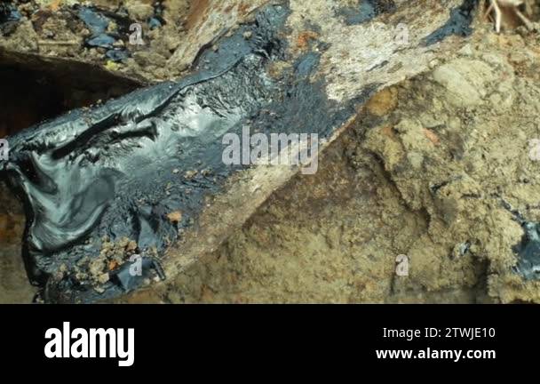 Toxic tar asphalt chemical in detail and closeup clay. Former dump ...