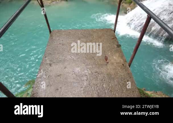 Walking down and looking over the edge of jumping platform overlooking ...