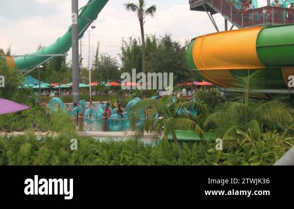 A Popular Water Park Scene Depicting People with Inflatable Tubes In ...