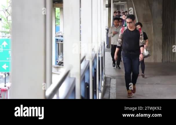 People walking on the walking bridge under the BTS rail train Stock ...