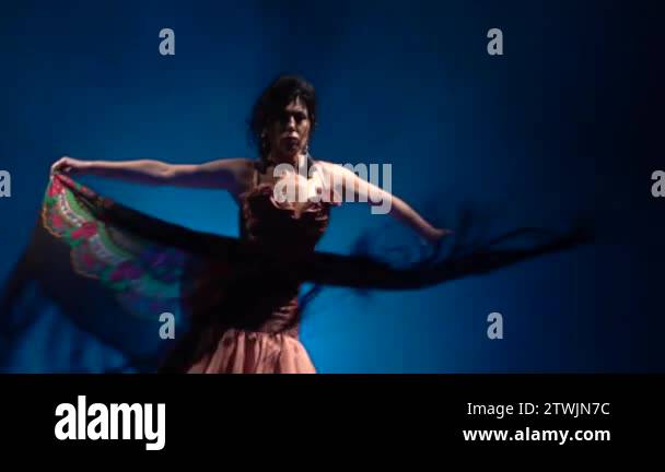 Flamenco. Girl is dancing with a manton in her hands . Light from ...