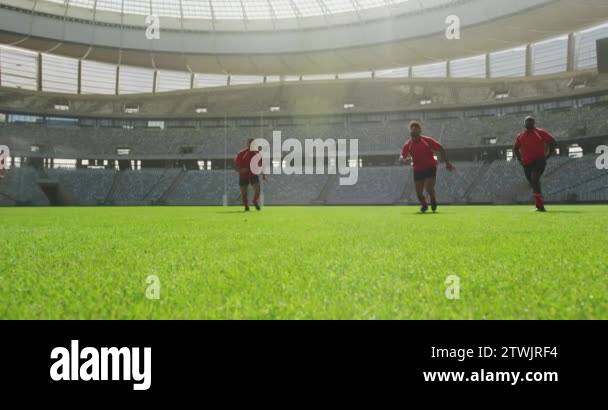 Low angle view of diverse rugby players playing rugby match in stadium ...