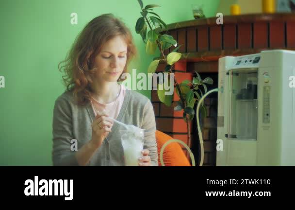 A woman drinks an oxygen cocktail with a device for oxygen scum. Oxygen ...