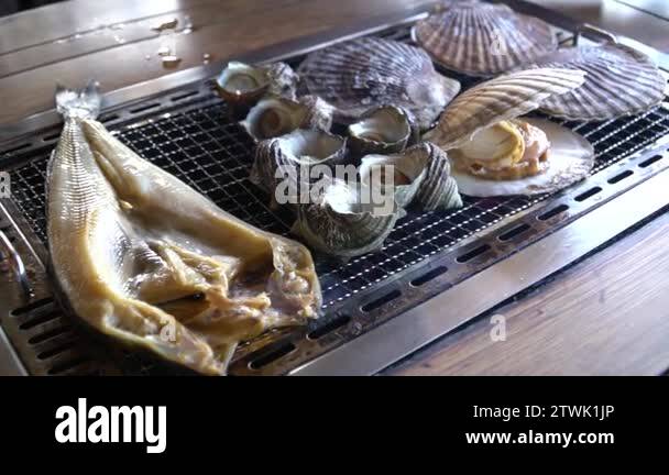 Various kind of grilled sea shells scallop(Hotate), horned turban sea ...