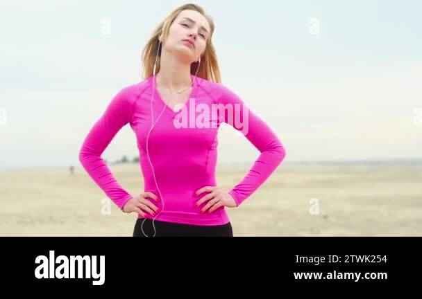 beautiful young athletic woman doing exercise with head turns ...