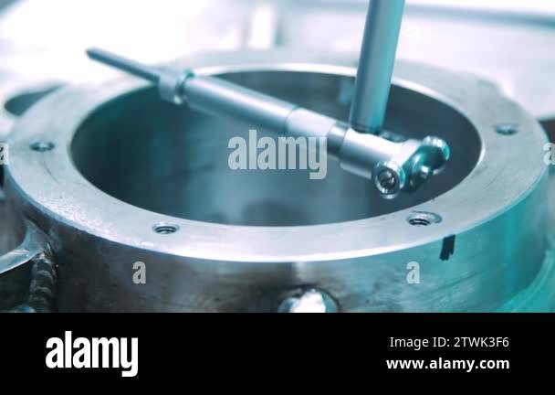 Technical measurements of parts. Metal rod is inserted into steel ...