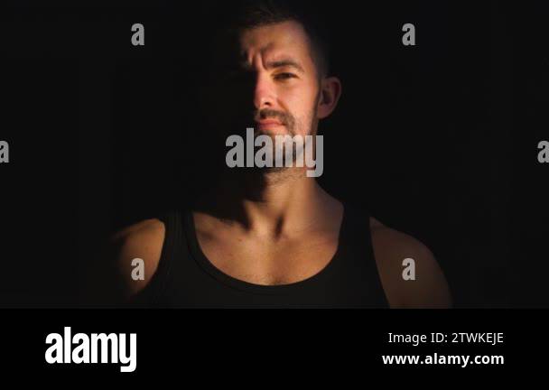 strong muscular bearded bodybuilder clapping hands with chalk powder ...