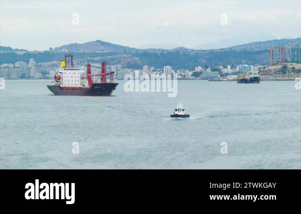 Cargo Freighter Ship Arriving in Valparaiso Chile Guided by a Tugboat ...