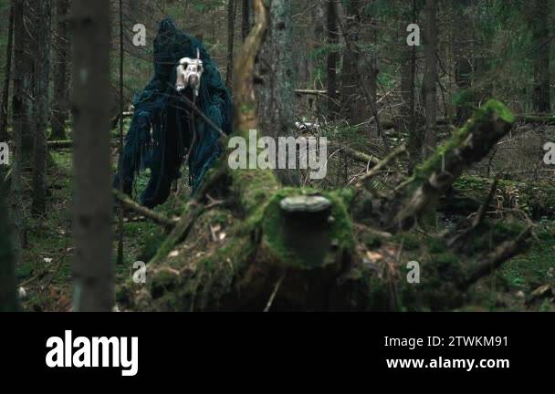 Horrible creature standing among trees in forest. Terrible monster ...