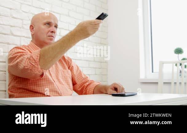 Relaxed Man Changing TV Channels with Infrared Remote (Ultra High ...