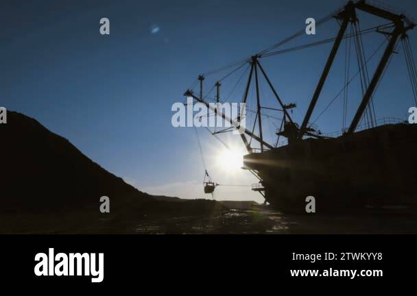 Dragline excavator loads ore. This area has been mined for buaxite ...