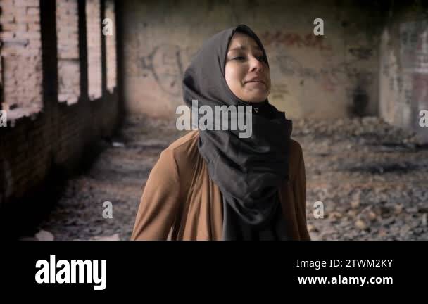 Young muslim woman in hijab screaming at armed soldier, standing in ...