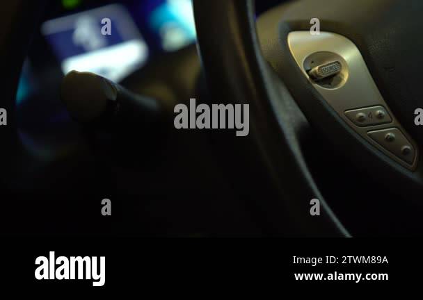 Driver hand pressing source button on steering wheel, testing modern ...