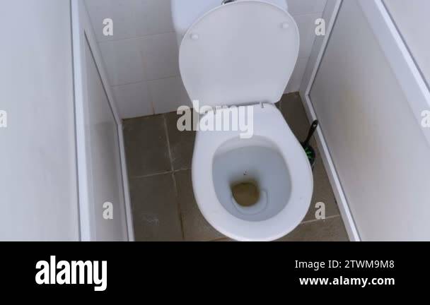 The Camera Moves Inside the Public Toilet Cubicle. Close-up view into ...