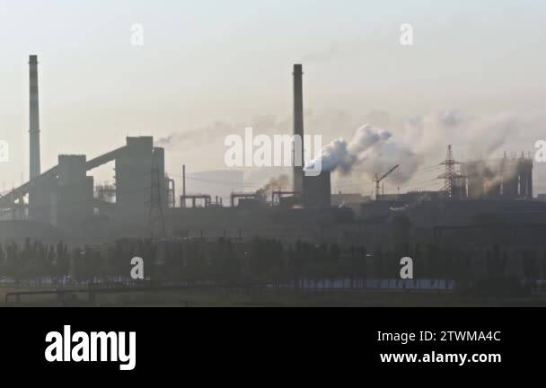 Billowing steam from smoke stack filling sky. Smoking chimneys of a ...