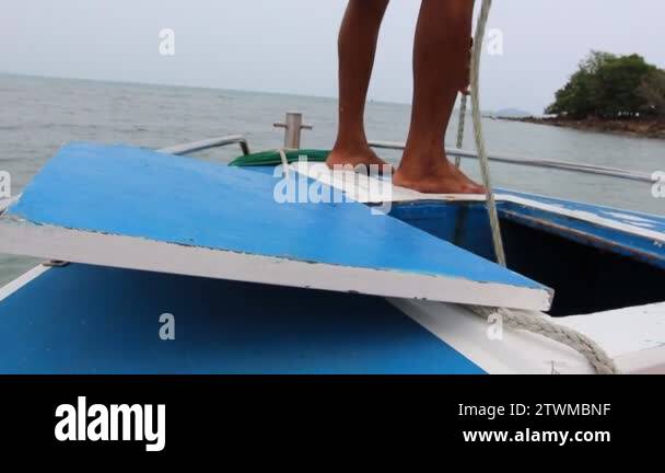 video of male barefoot feet on boat with rope and anchor Stock Video ...