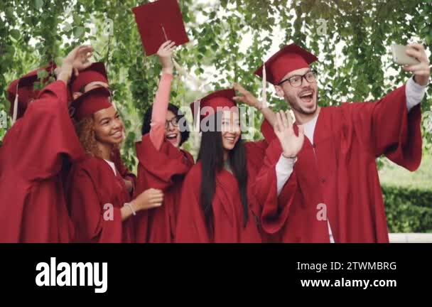 Graduating students girls and guys are taking selfie on graduation day ...