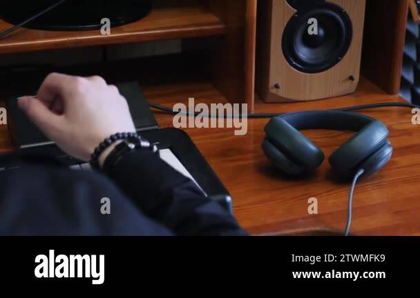 Headphones and midi piano keyboard at home studio with sound engineer ...