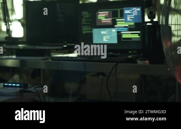 Developer and hacker hidden workstation: multiple screens and connected computers on a desktop ...