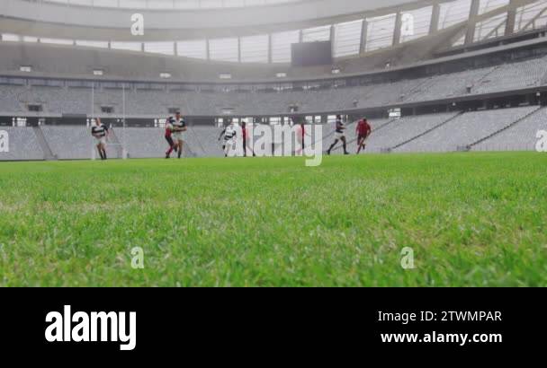 Front view of diverse rugby players playing rugby match in stadium ...