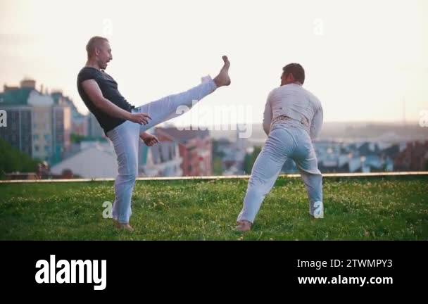 Men with a strong physique show Brazilian dance capoeira, fun fighting ...
