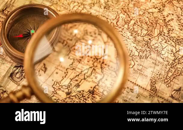 Magnifying glass on ancient map Stock Video Footage - Alamy