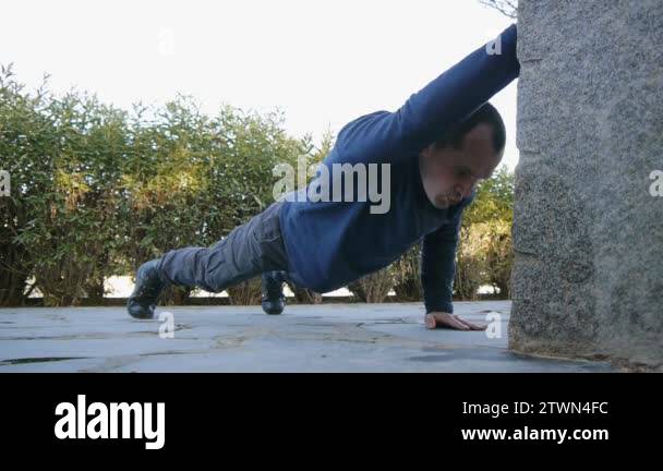 Workout with personal trainer outdoors. Male athlete in military style ...