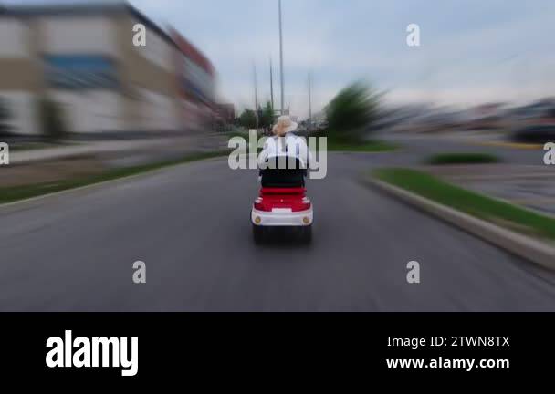 Timelapse and hyperlape of disabled person driving a motorized mobility ...