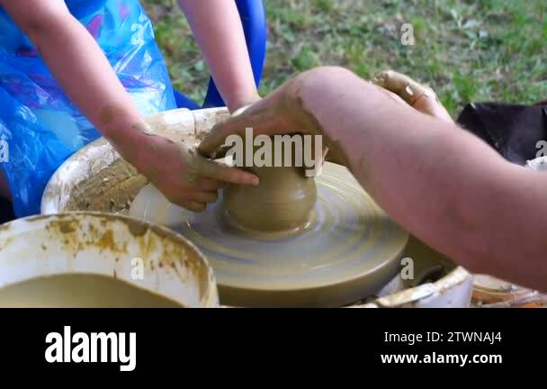 The potter's hands are shaped a cup from a clay. The process of ...