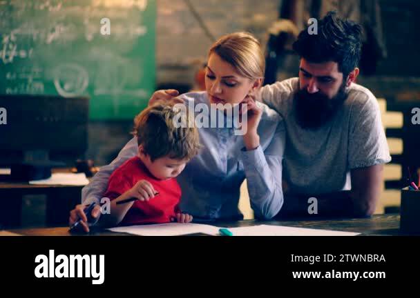 The boy shows his drawings to parents in the school class. Learning ...