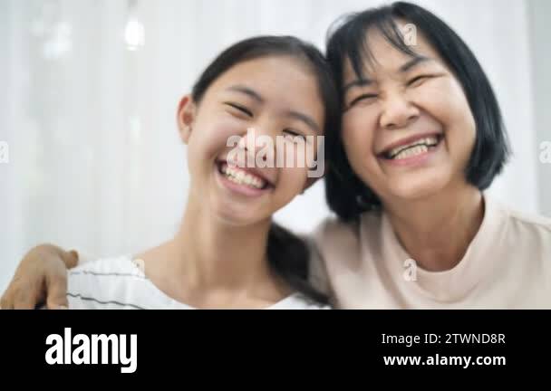4K Close up smiling face of happy Asian girl hugging her grand mother, Multi generation of Asian ...