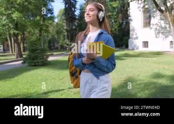 Front view of two beautiful students of African and European descent, standing together. Women ...