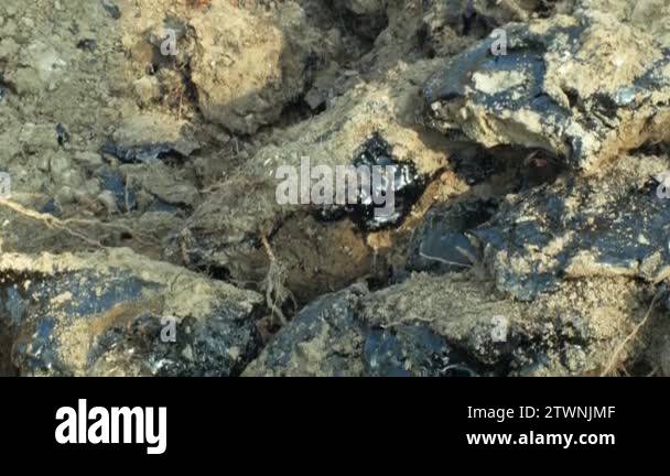 Toxic tar asphalt chemical in detail and closeup clay. Former dump ...