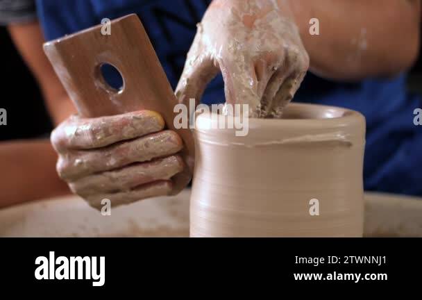 Traditional pottery making, man teacher shows the basics of pottery in ...