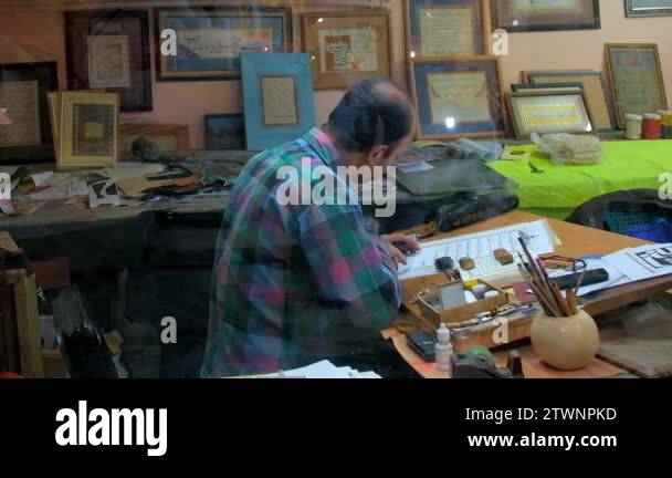 KASHAN, IRAN - OCTOBER 23, 2017: Calligrapher rewrites the surahs of ...