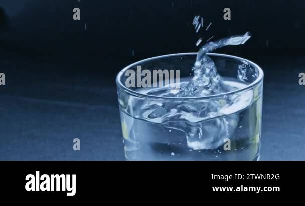 ice cube falling into glass of clean water Stock Video Footage - Alamy