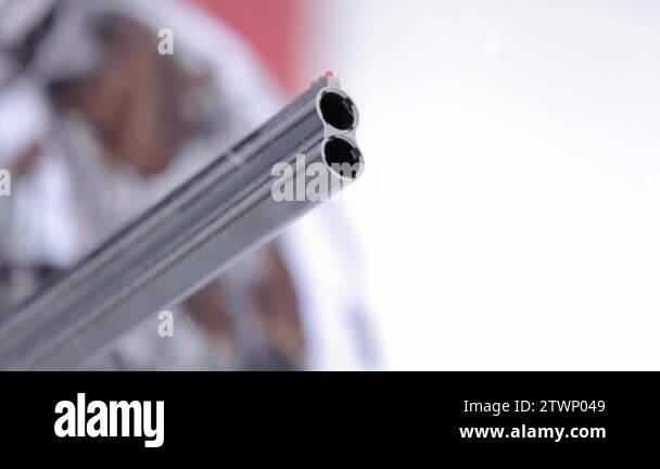 A close up panorama view of rifle. Mans hand hold a double-barrel rifle ...