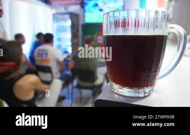 Watching football game on television at local pub. Food, beer. a mug ...