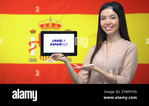 Woman holding tablet with do you speak spanish phrase, app for learning ...