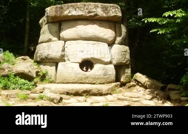 tourists, exploring the ancient dolmen, take photos on the phone for ...