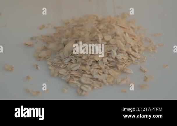 Pile of oatmeal isolated on white background Stock Video Footage - Alamy