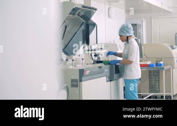 Automated laboratory equipment with workers at a production of ...