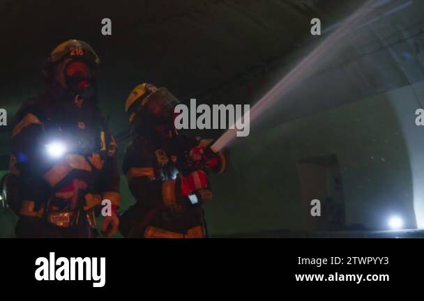 Car accident scene inside a tunnel, firefighters rescuing people from ...