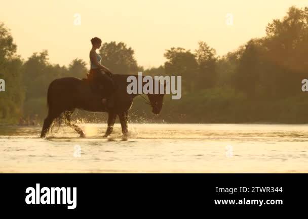 SLOW MOTION CLOSE UP, DOF: Pretty young woman horseback riding stunning ...