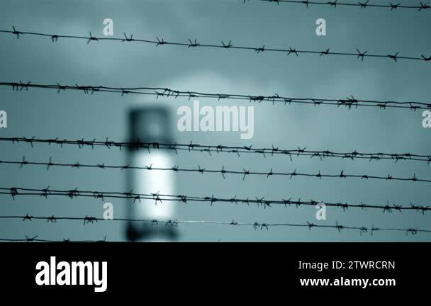 Barbed wire and pipe with smoke, background blue clear sky real time ...