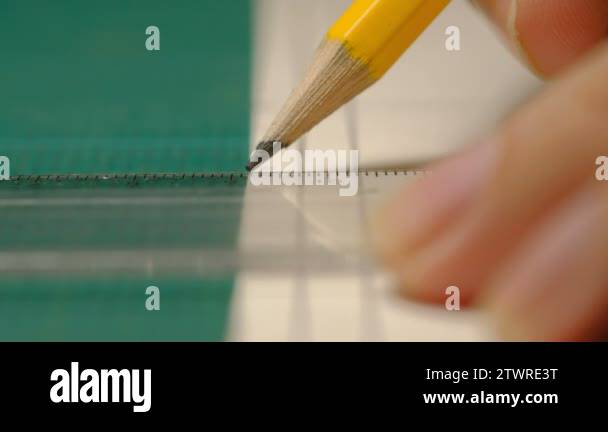Close-up of male architect hands drawing a line on white paperboard ...