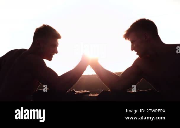 Two men with hands clasped in arm wrestling challenge. Bodybuilding ...