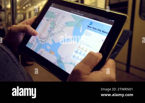 Man in underground examines the subway map using the tablet Stock Video ...
