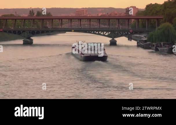 France. Paris. Summer evening on the Seine. Barges float on the water ...