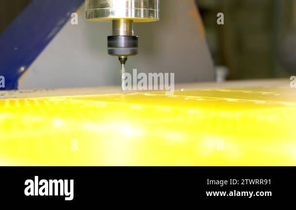 Drilling holes in a plastic part on a CNC machine. Side view Stock ...